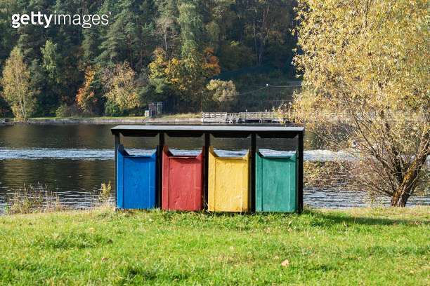 old Colorful Recycle Bins In The Park. urns for separate collection of ...