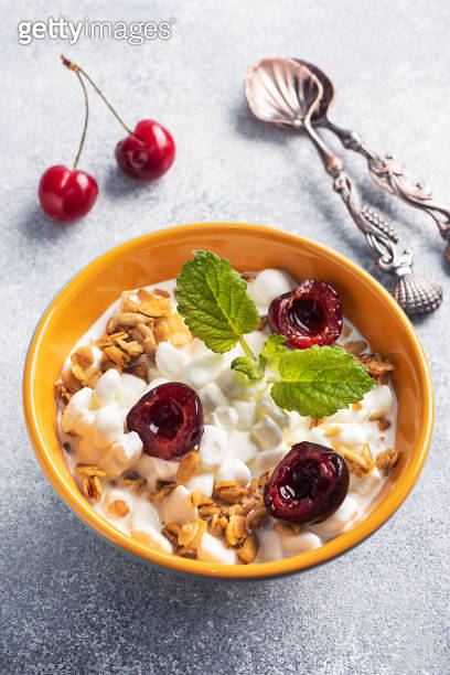 Grain curd muesli with fresh cherries on a plate. Concept healthy ...