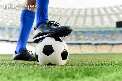 legs of professional soccer player in blue socks and soccer shoes on ...