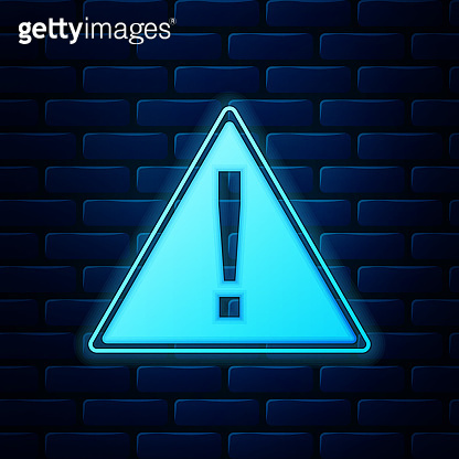 Glowing neon Exclamation mark in triangle icon isolated on brick wall ...