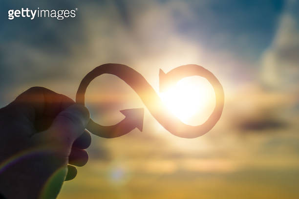 Infinity symbol in hand on a sunset background. Business concept idea ...