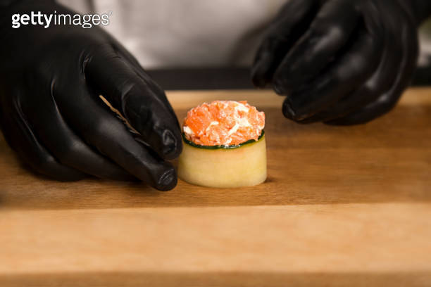 Japanese Gunkan Sake Green with Salmon, cream cheese and rice wrapped in cucumber. Chef ...