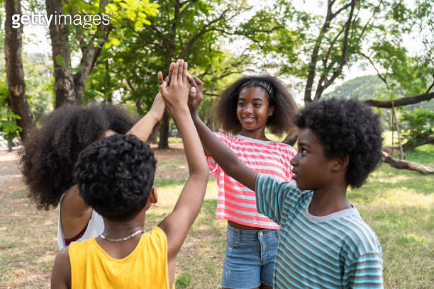 Group of children joining hands together standing in the park, Kids ...