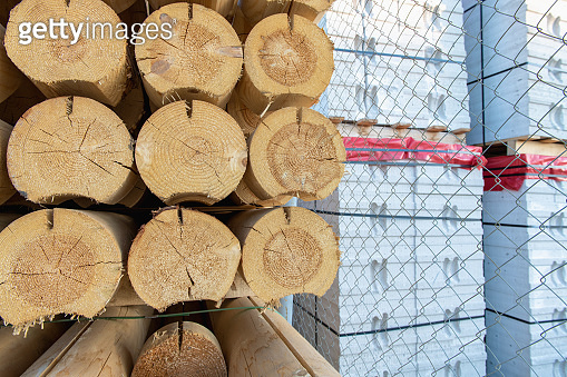 Wooden balk, timber, beam and building material stacked at construction ...
