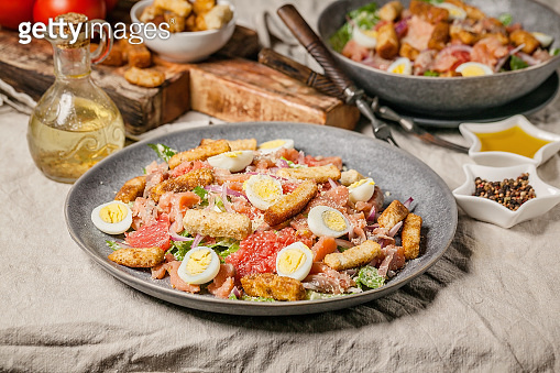 Close-up Caesar salad with red fish, romaine lettuce, quail eggs ...