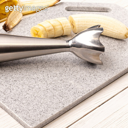 Grinding a banana on a cutting board made of artificial stone 이미지 ...