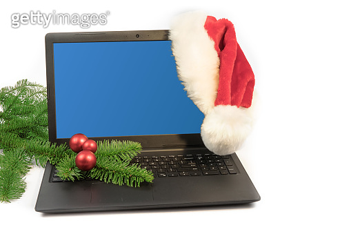 a red Santa Claus Christmas hat on a notebook computer isolated on ...