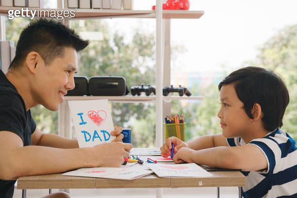 asian dad and son have good time drawing gift card for father day ...