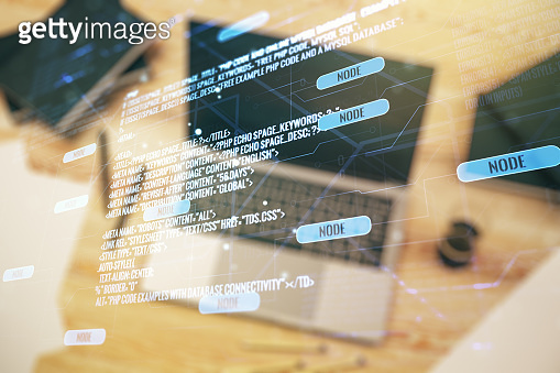 Double exposure of abstract programming language on laptop background ...
