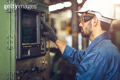 worker operate CNC machine with G-Code monitor, high skill labor work ...