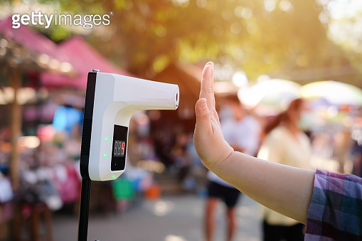 People using infrared contactless temperature assessment devices for ...