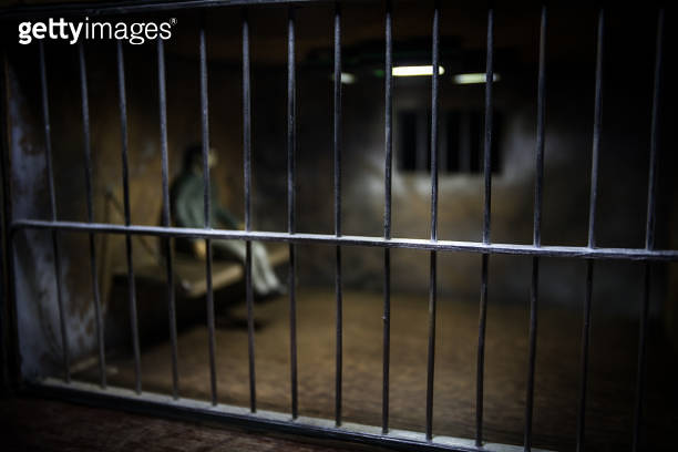 Jail or prison cell. Man in prison man behind bars concept. Old dirty ...