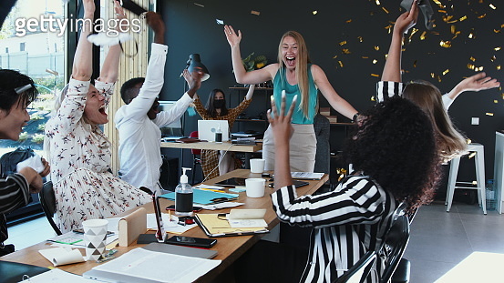 COVID-19 is over. Happy multiethnic business people team take masks off ...