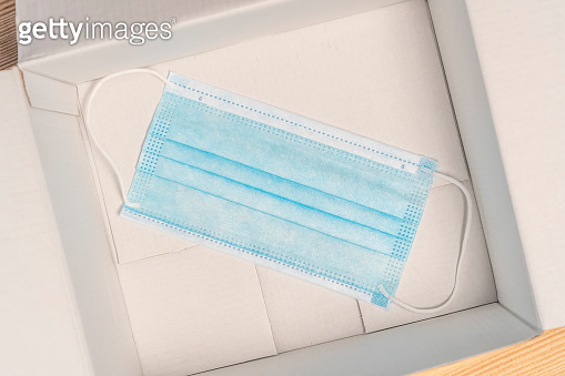 Surgical protective mask in a cardboard box. Medical respirator mask ...