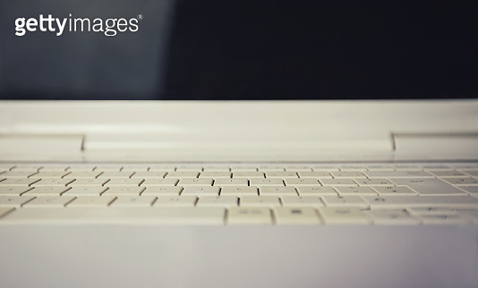 Close up of retro white laptop keyboard. Old computer background ...