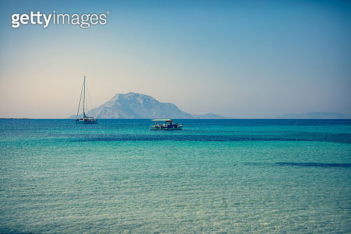Sailing boat at distant remote island paradise with exotical vivid ...