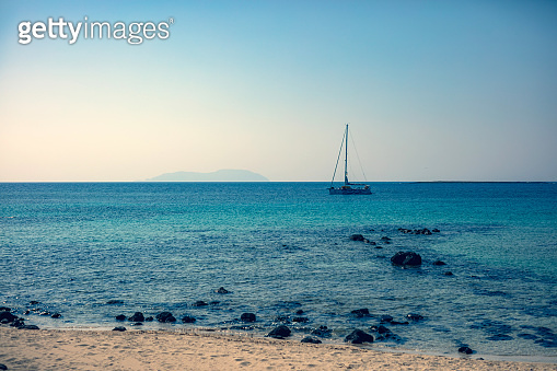 Sailing boat at distant remote island paradise with exotical vivid ...