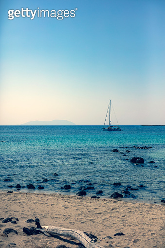 Sailing boat at distant remote island paradise with exotical vivid ...