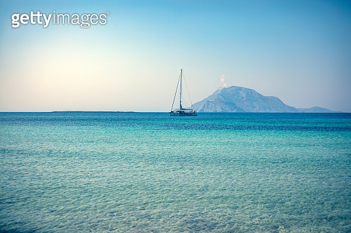 Sailing boat at distant remote island paradise with exotical vivid ...