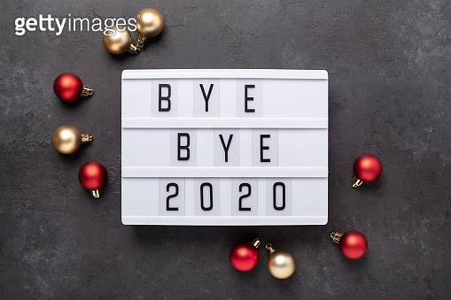 Lightbox with text BYE BYE 2020 on dark background. Top view. New year ...