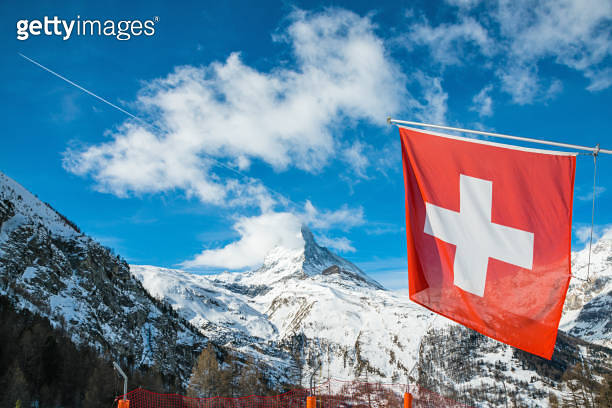 World famous Matterhorn above Zermatt with Switzerland national flag ...