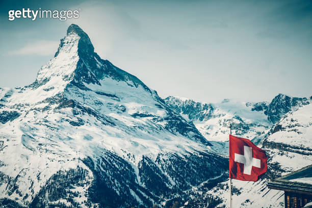 World famous Matterhorn above Zermatt with Switzerland national flag ...