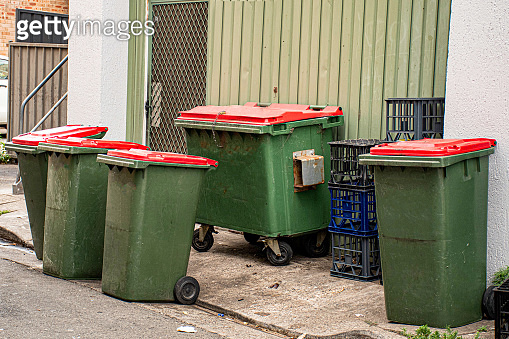 Australian garbage wheelie bins with red lids for general waste on the ...