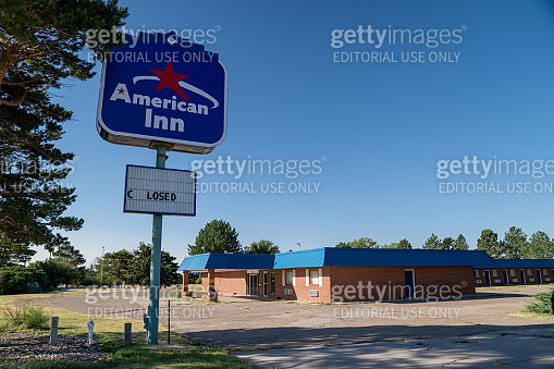 Sign for a closed and abandoned American Inn hotel off of Interstate 70 ...
