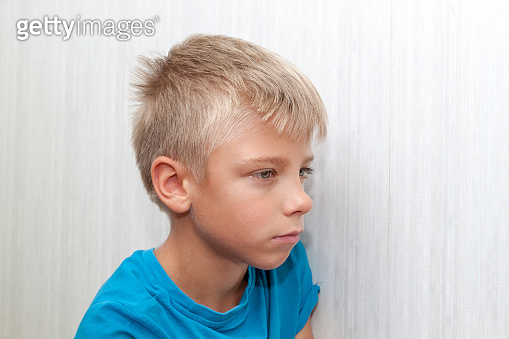 Portrait of pensive dreamy boy to something he imagines in mind ...