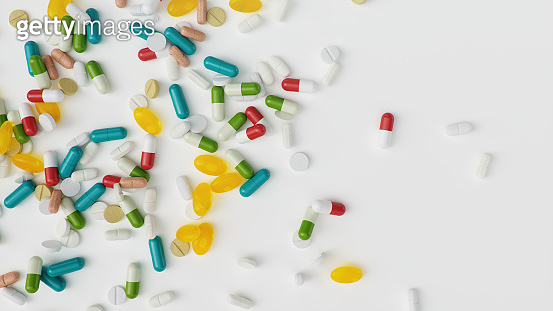 Many different colored tablets, capsules isolate on white background ...