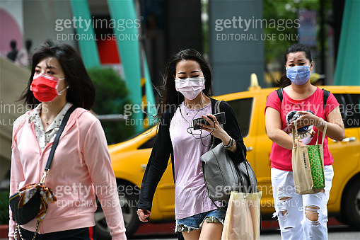 People wearing protective face masks on a street in Taipei city, Taiwan ...