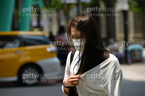 People wearing protective face mask on a street in Taipei city, Taiwan ...