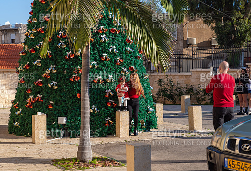 Father of the family takes pictures of mother with little daughter ...