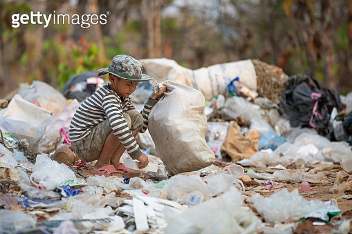 Poor boy collecting garbage in his sack to earn his livelihood, The ...