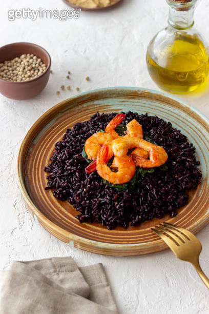 Black rice risotto with shrimp. Sea food. Diet. Healthy eating ...