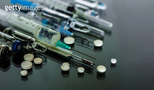 Thermometer, pills, injection vaccine ampoules, syringe for vaccination ...