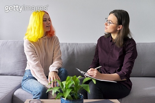Teen girl giving interview to social worker. School psychologist ...