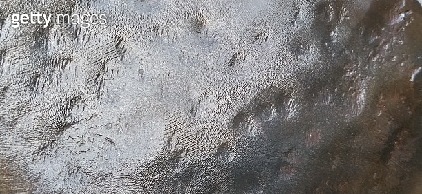 Bronze metal surface. Uneven metal texture with scratches, gouges and ...