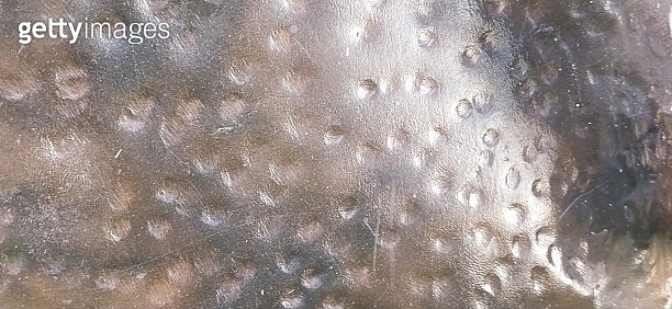 Bronze metal surface. Uneven metal texture with scratches, gouges and ...