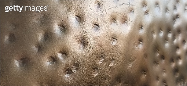 Bronze metal surface. Uneven metal texture with scratches, gouges and ...