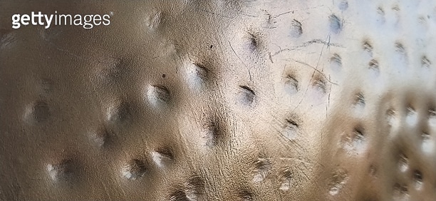 Bronze metal surface. Uneven metal texture with scratches, gouges and ...