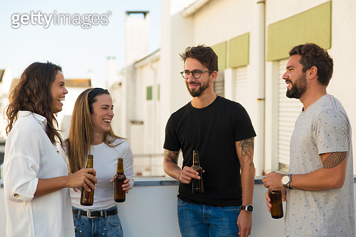 Smiling friends talking while drinking beer at balcony 이미지 (1200771419 ...