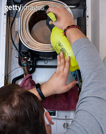 plumber repairing a condensing boiler in the boiler room. 이미지 ...