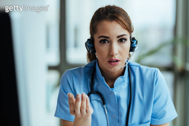 Serious medical customer service representative communicating with ...