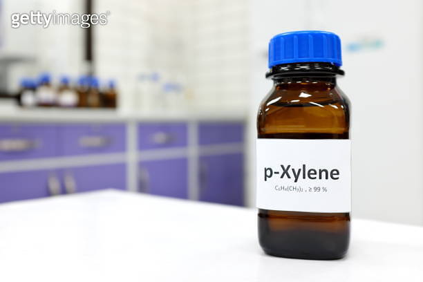 Selective focus of xylene liquid chemical compound in dark glass bottle ...