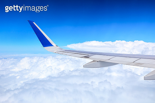 Airplane flying at high altitude and beautiful high-altitude clouds in ...