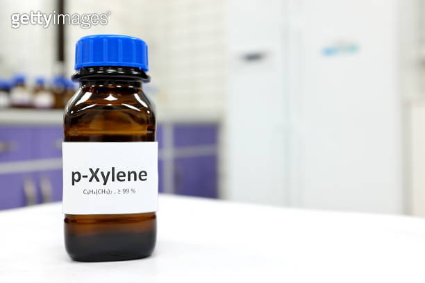 Selective focus of xylene liquid chemical compound in dark glass bottle ...