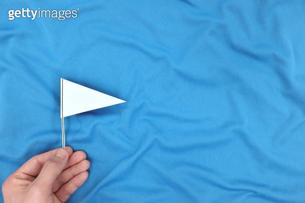 Peace, ceasefire, truce, surrender and retreat concept. Hand holding a ...