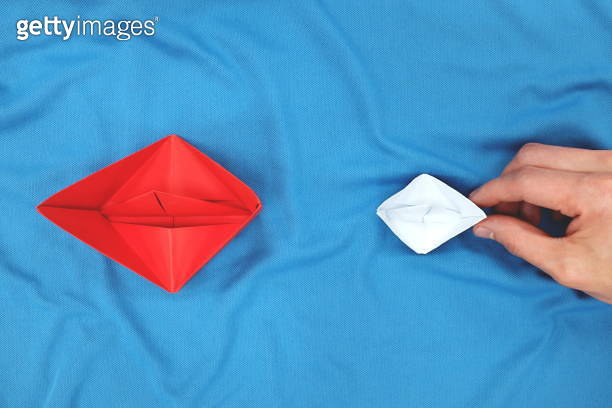 Business startup competition against big players. Small and big paper ...