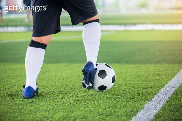 Soccer player control to shoot ball on green artificial turf to goal ...